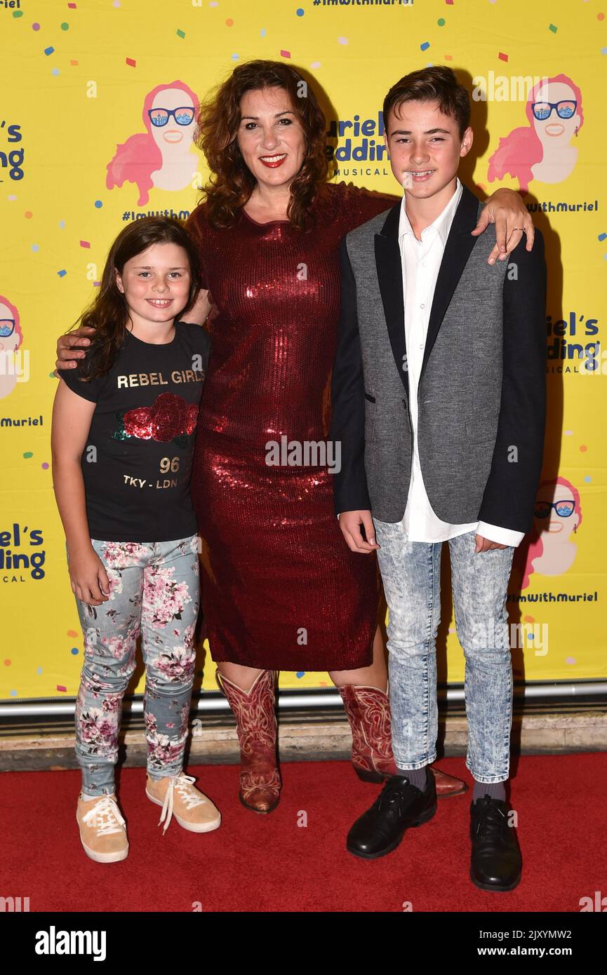 Marg Downey (centre) poses for a photograph on the red carpet at the ...