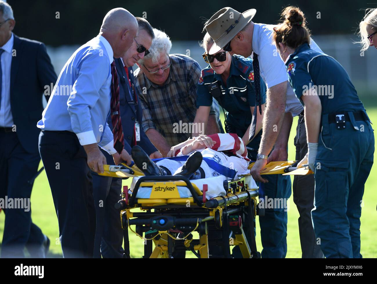Jockey Clayton Gallagher is taken away by paramedics after he was ...