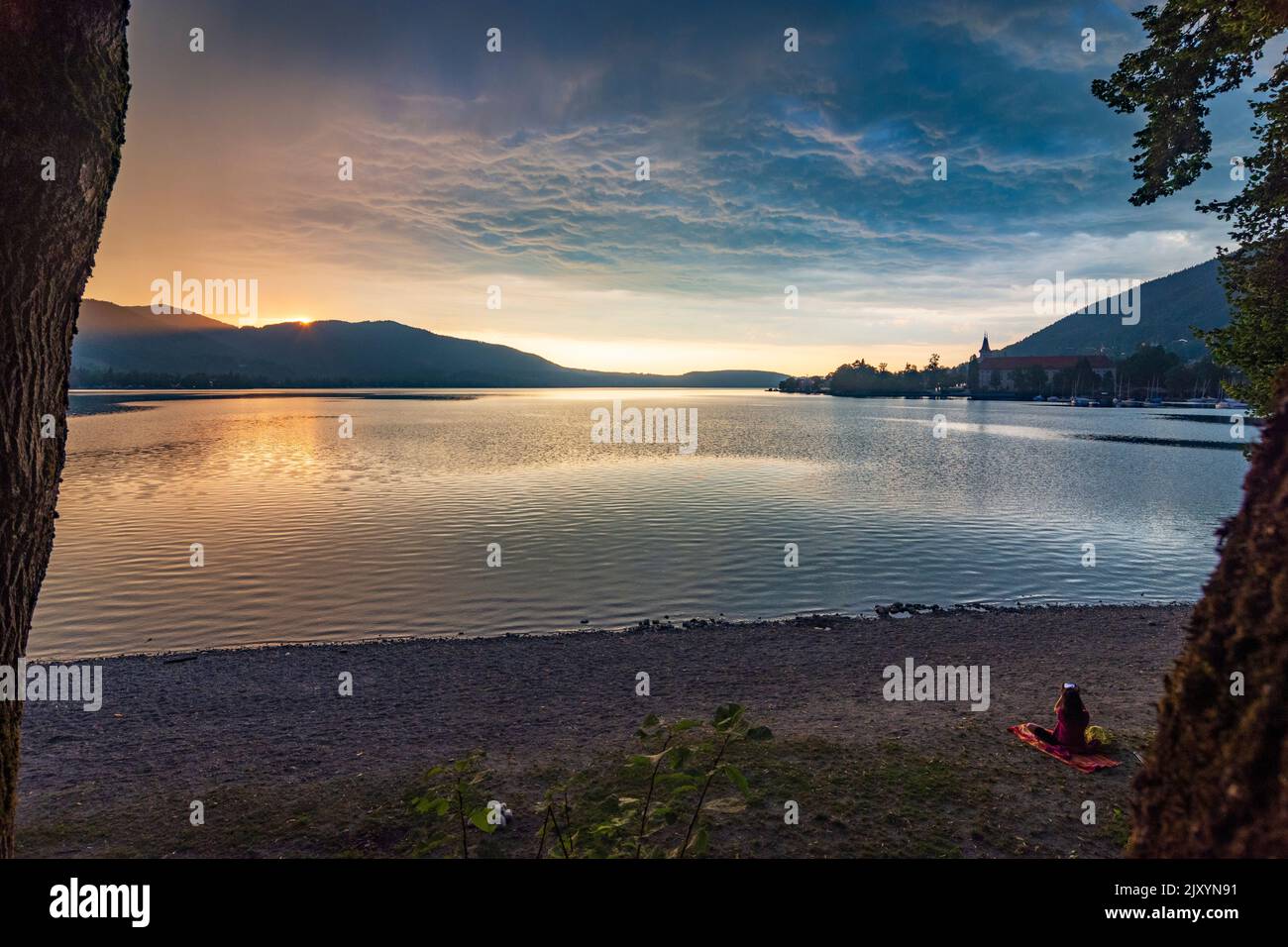Tegernsee: lake Tegernsee, view to Tegernsee town at sunset, woman ... Tegernsee: lake Tegernsee, view to Tegernsee town at sunset, woman ...