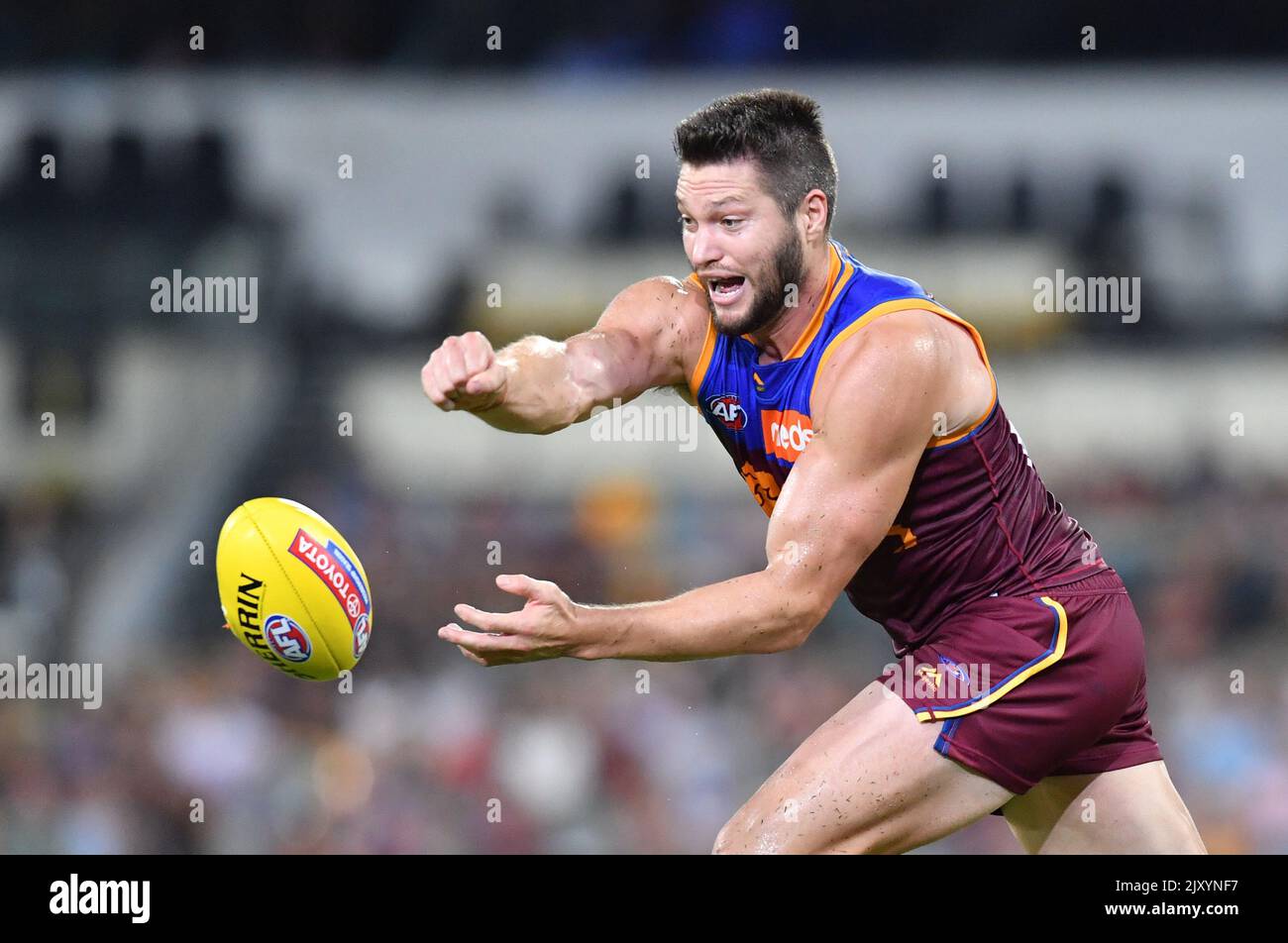 Stefan Martin of the Lions handballs during the Round 1 AFL match ...