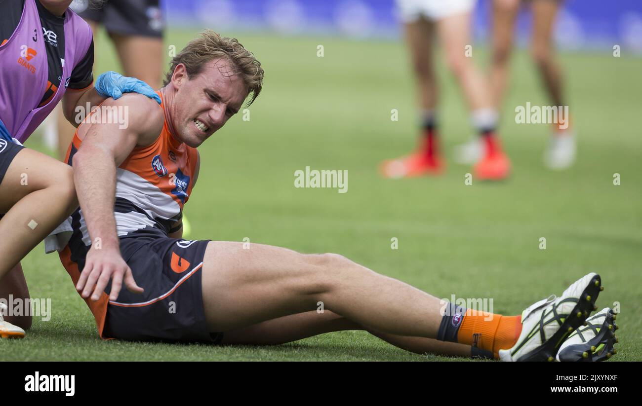 Lachlan Keeffe of the Giants is injured and leaves the field during the ...