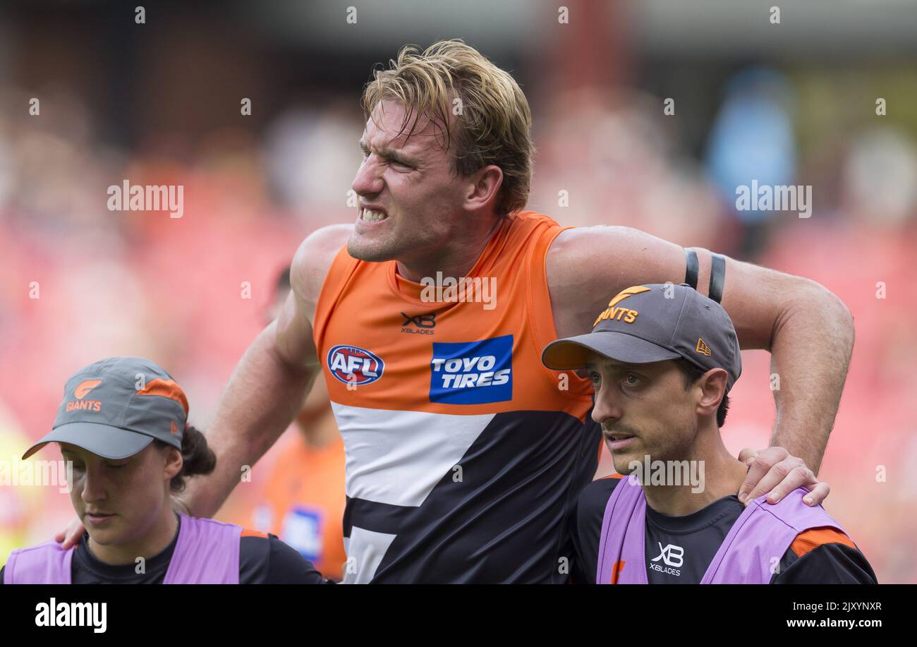 Lachlan Keeffe of the Giants is injured and leaves the field during the ...