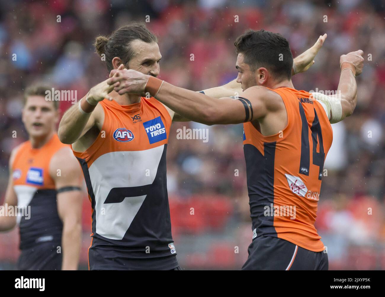 Tim Taranto of the Giants (right) scores during the Round 1 AFL match ...