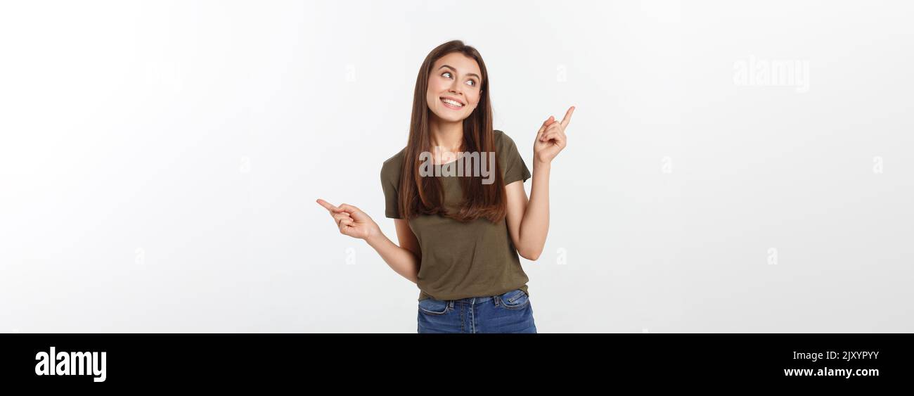 Portrait happy and surprised young lady standing isolated over grey ...