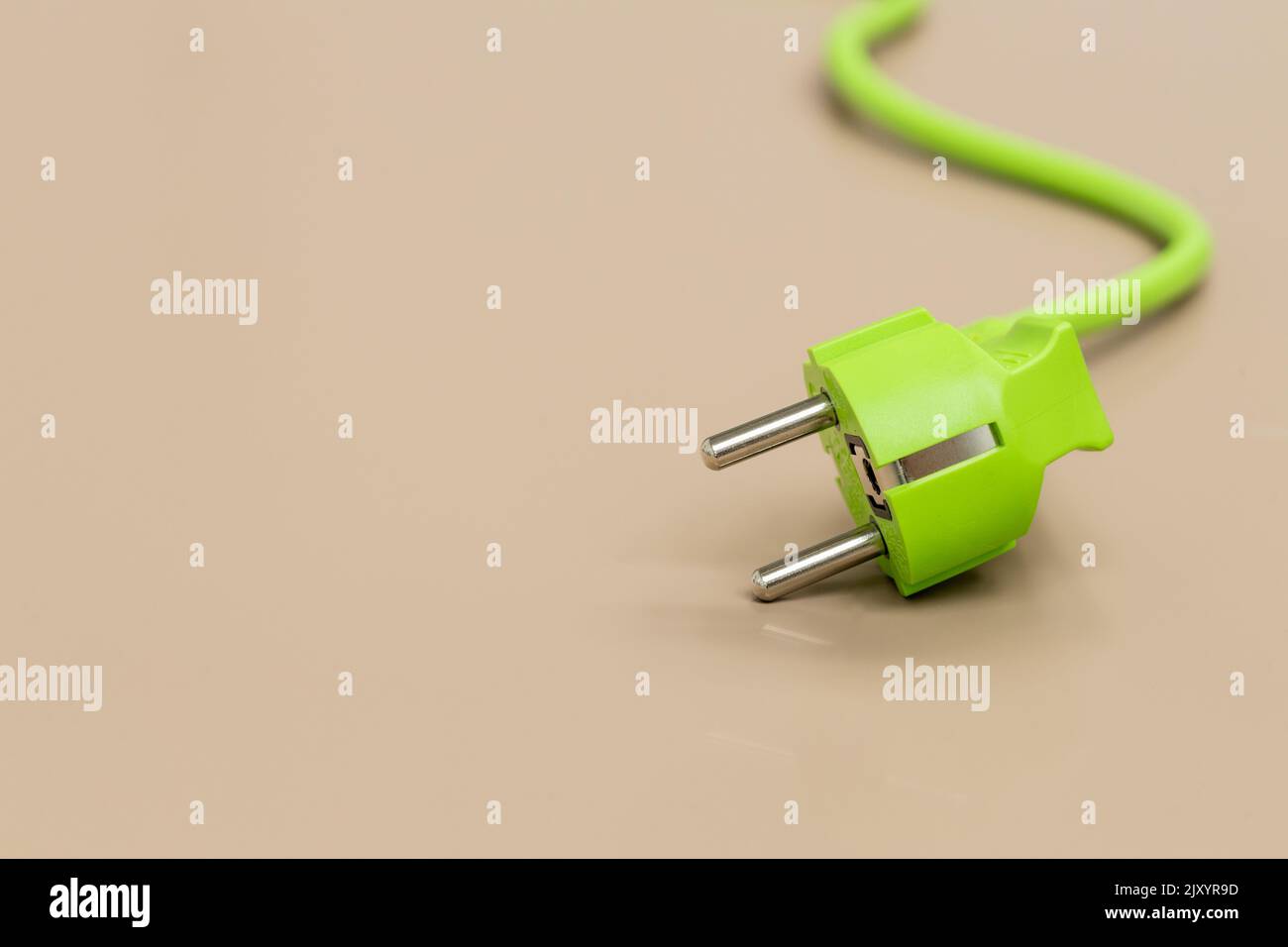 Green power plug on light brown background, Copy space,Concept, Green ...