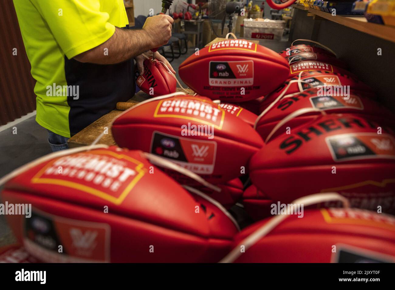 Staff work on the production of Sherrin footballs to be used in the ...