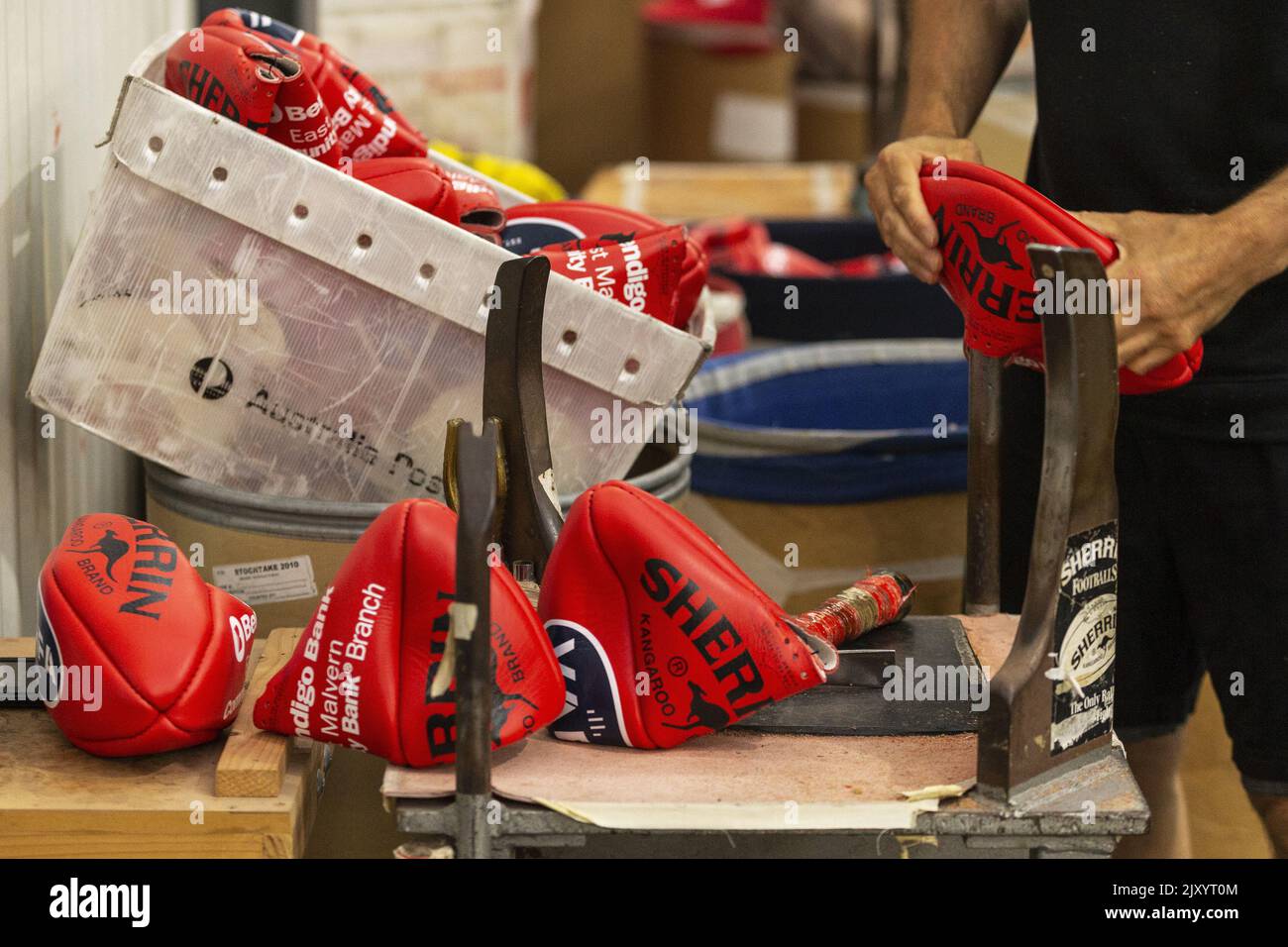 Staff work on the production of Sherrin footballs to be used in the ...