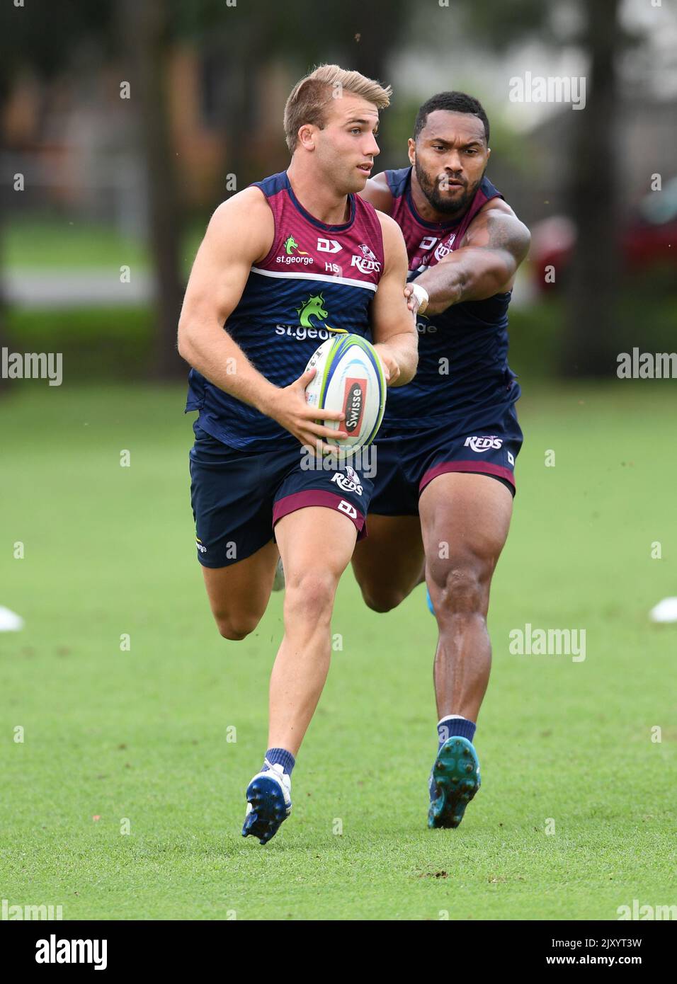 Queensland Reds player Hamish Stewart (left) is chased by Sefa Naivalu ...