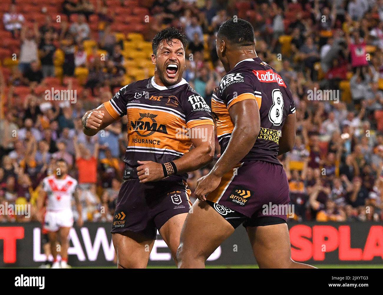 Alex Glenn of the Broncos (left) reacts after scoring a try during the ...