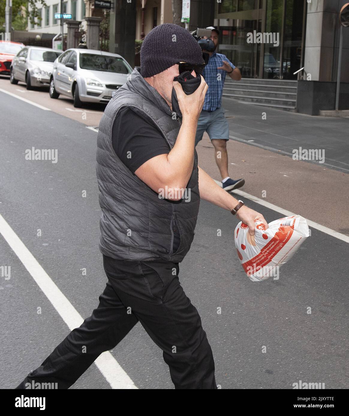 Workplace bullying claimant David Hingst covers his face as he leaves ...