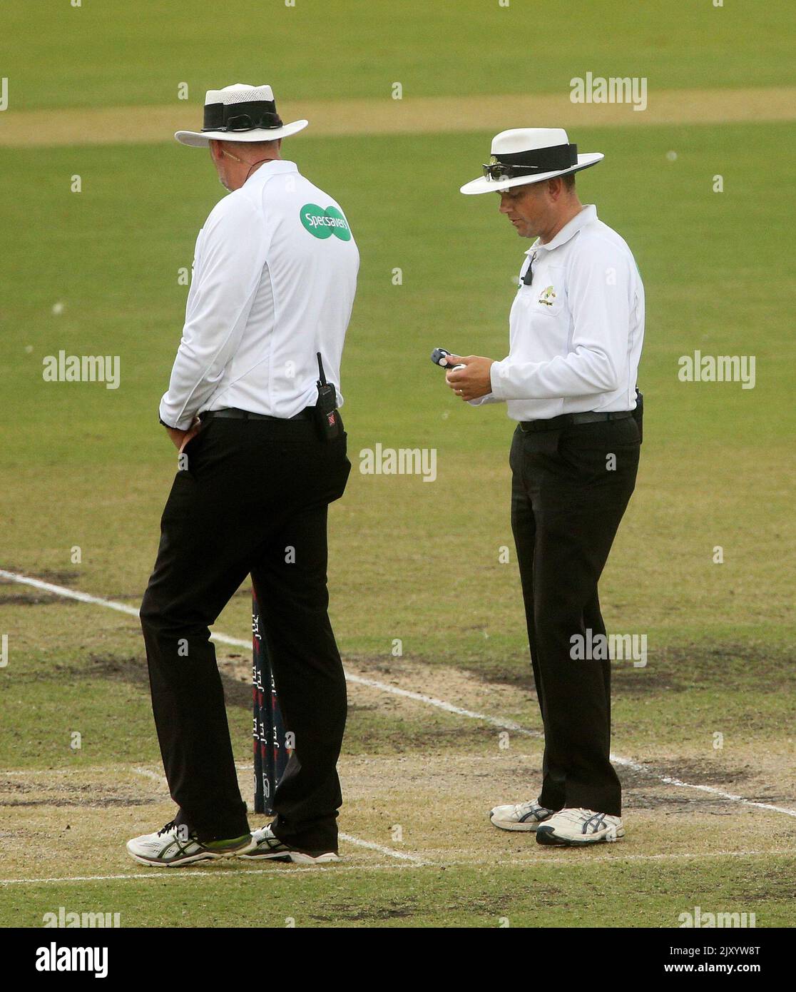 Umpire Paul Wilson (left) and Umpire Sam Nogajski as bad light stops ...