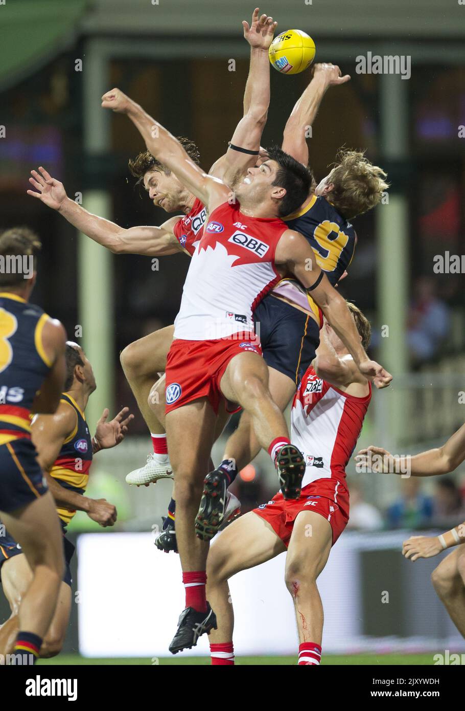 Jake Lloyd of the Swans and Rory Sloane of the Crows contest a mark ...