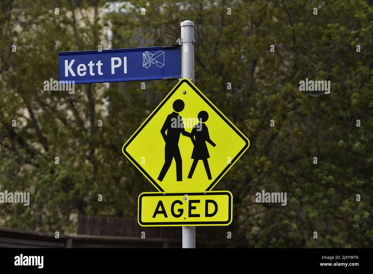 A hazard sign warning drivers of elderly members crossing the street is ...