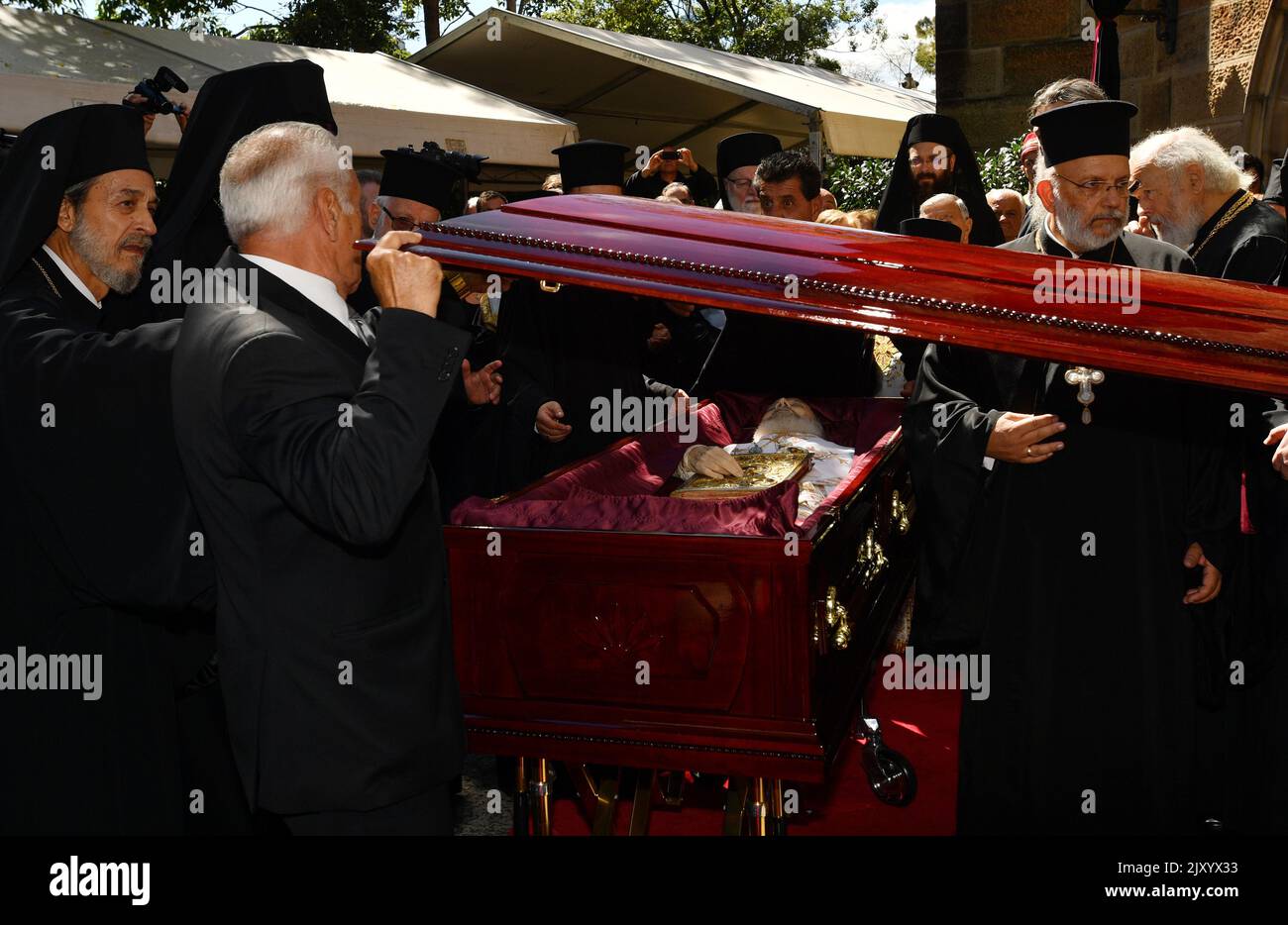 The casket lid is placed upon the coffin at the funeral of Greek ...