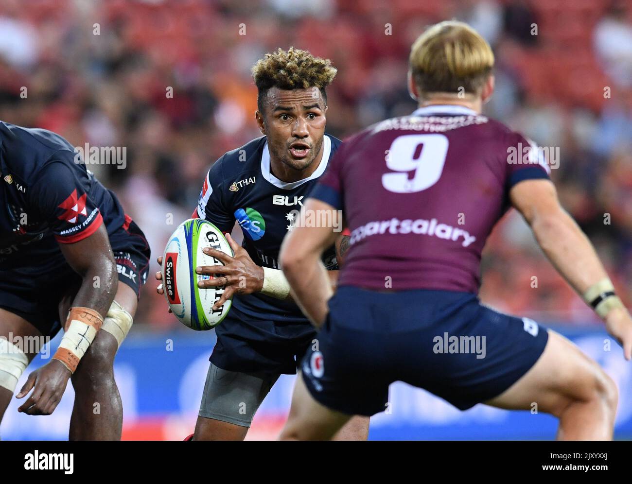 Will Genia of the Rebels (left) faces Tate McDermott of the Reds during ...