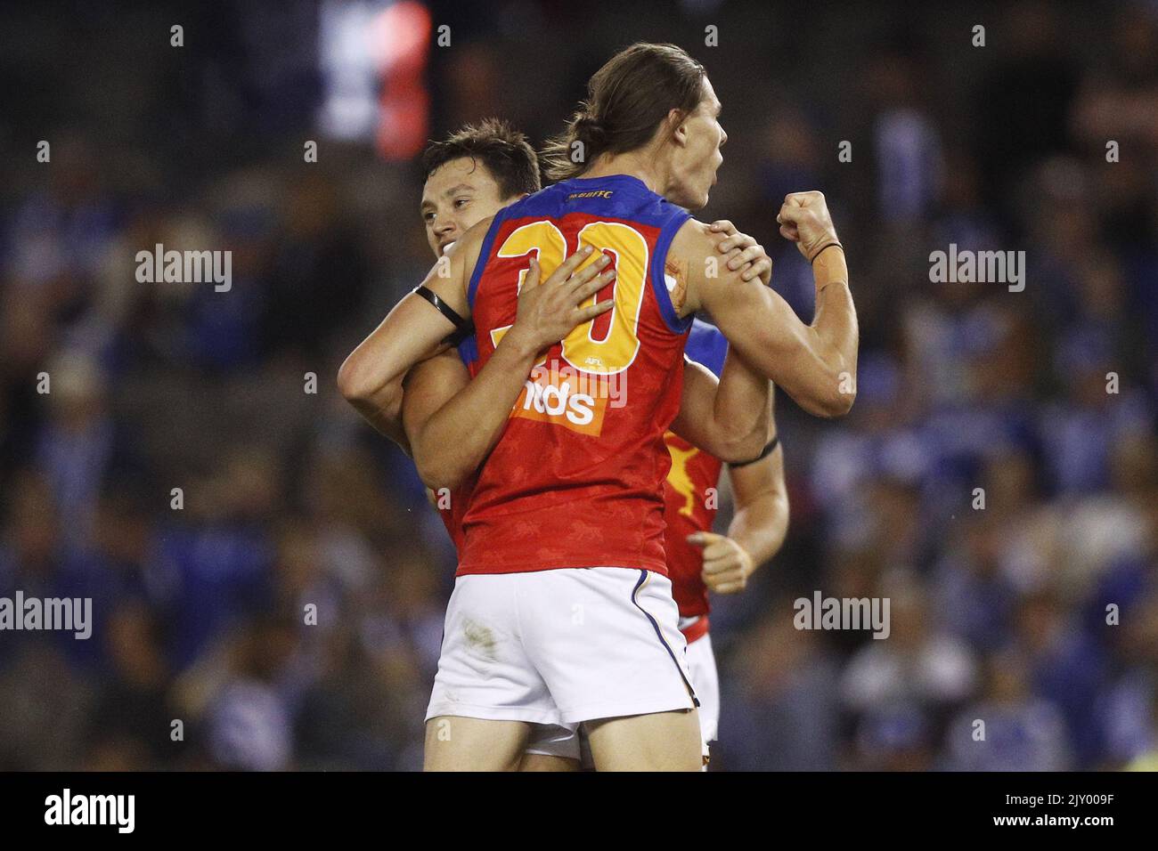 Eric Hipwood of the Lions (centre) celebrates a goal during the Round 2 ...