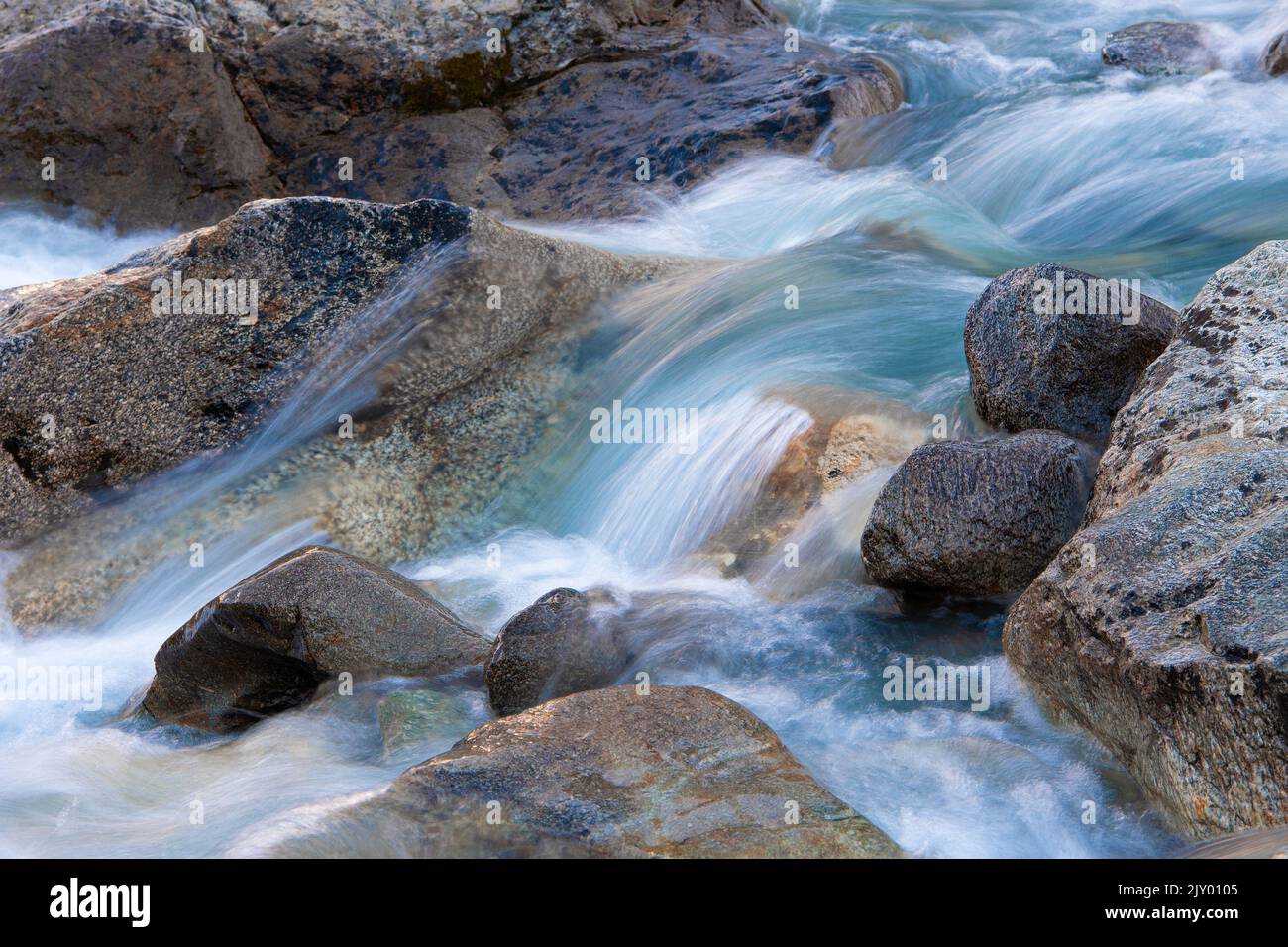 Long time exposure of the flowing water of a creek in the Swiss Alps ...