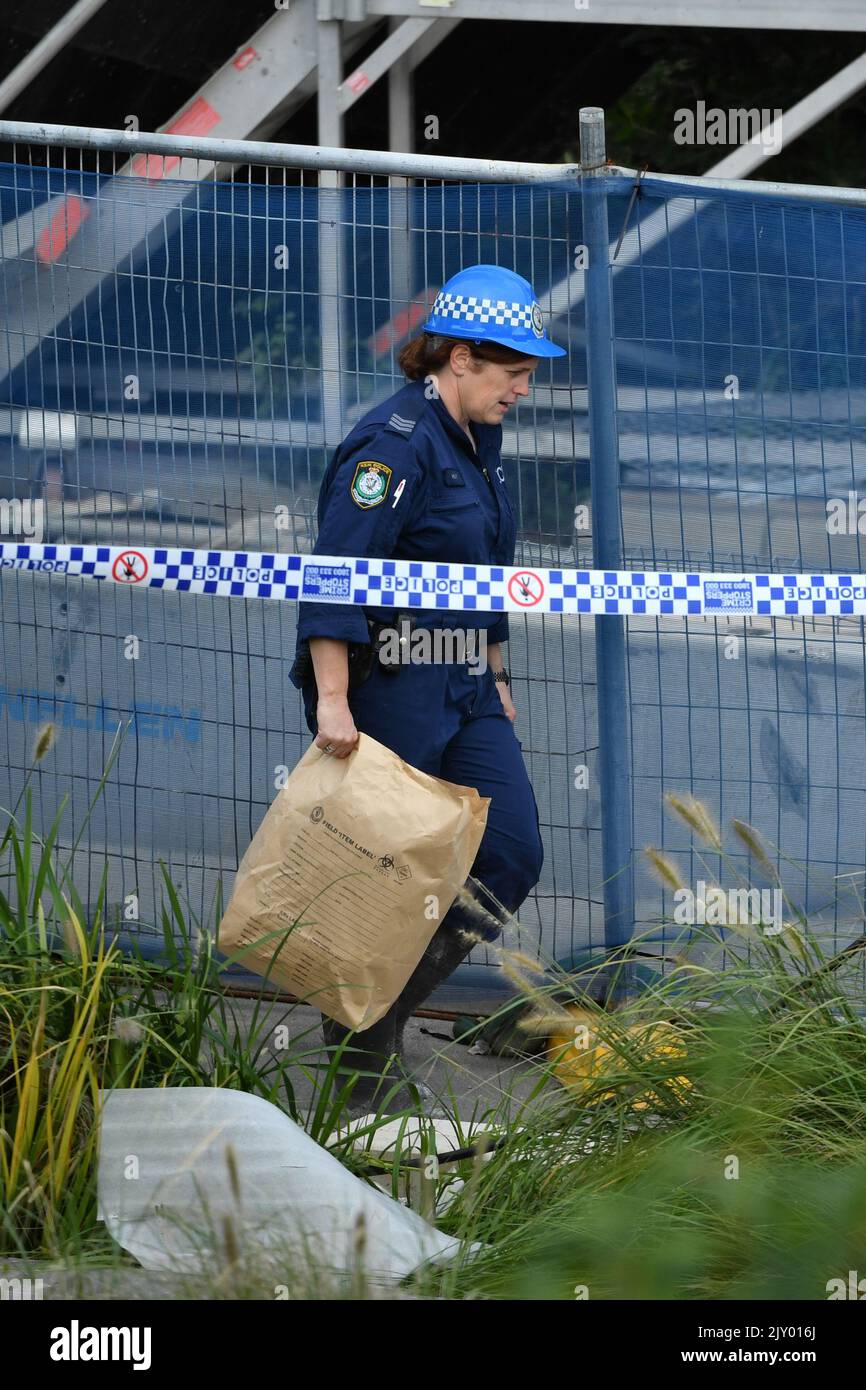 Rescue workers at the scene where a construction worker is trapped ...