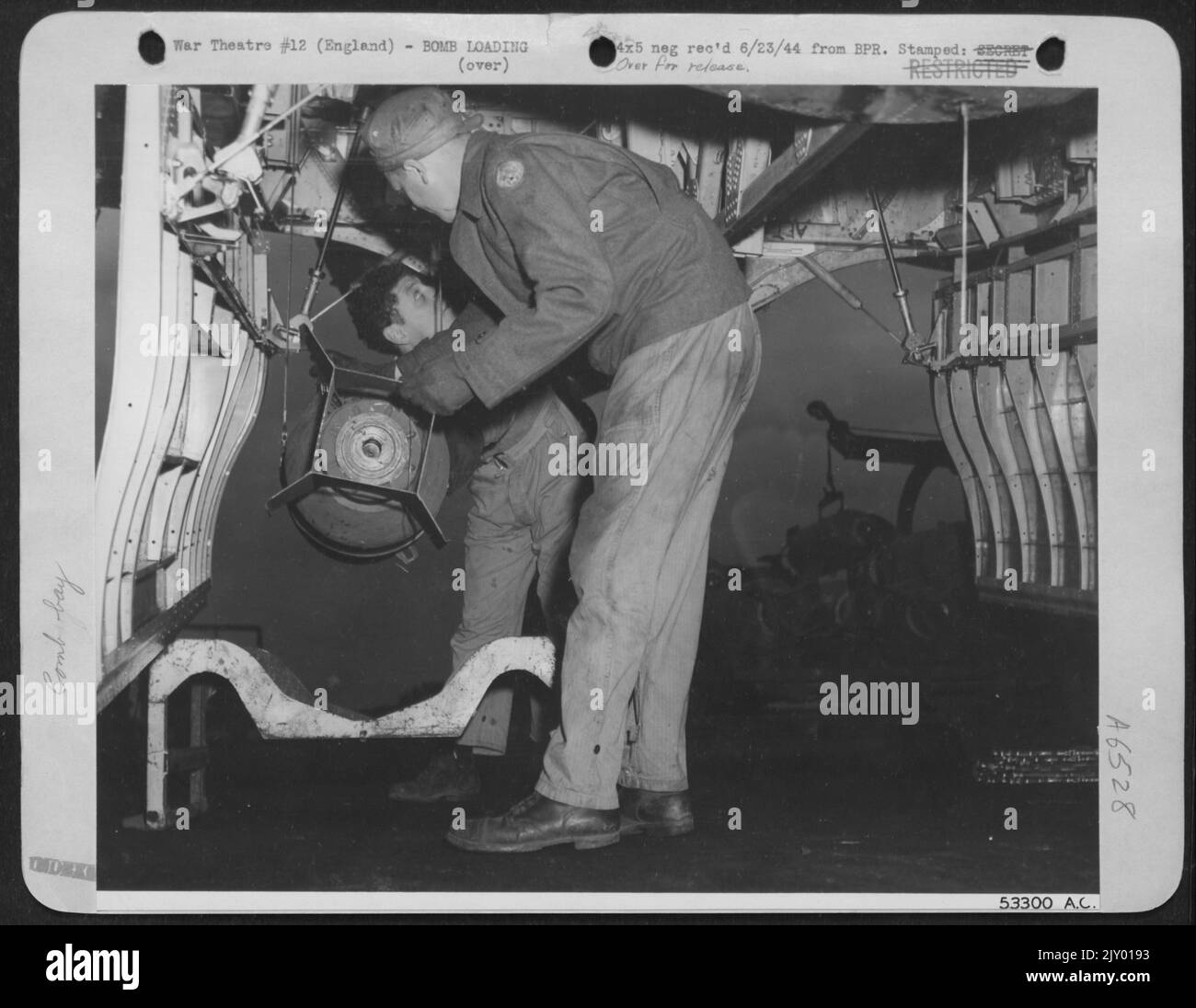 Two thousand pounder goes to bomb bay to complete loading of one of the ...