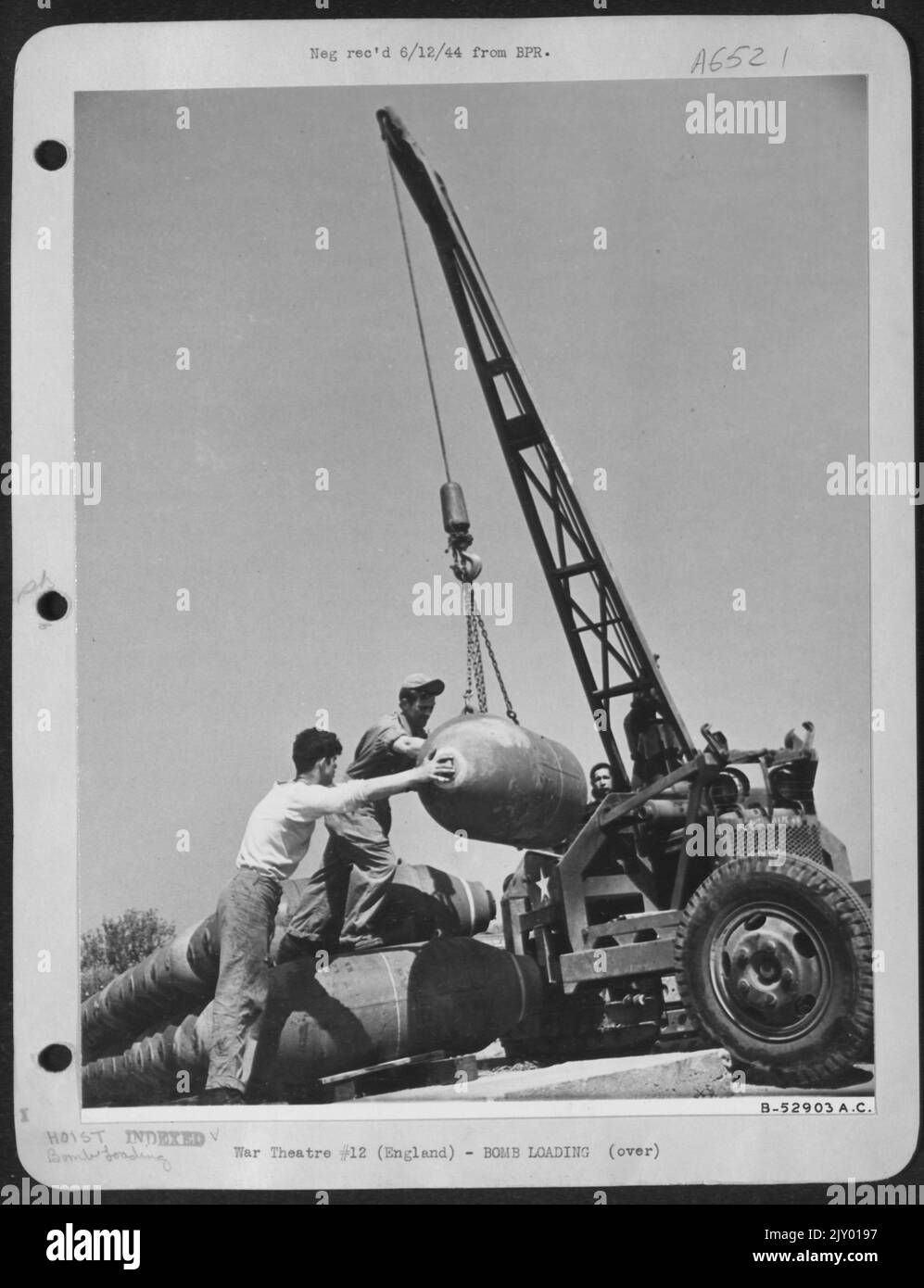 View of Ordnance crew at work loading a 2,000-pound GP bomb from ...