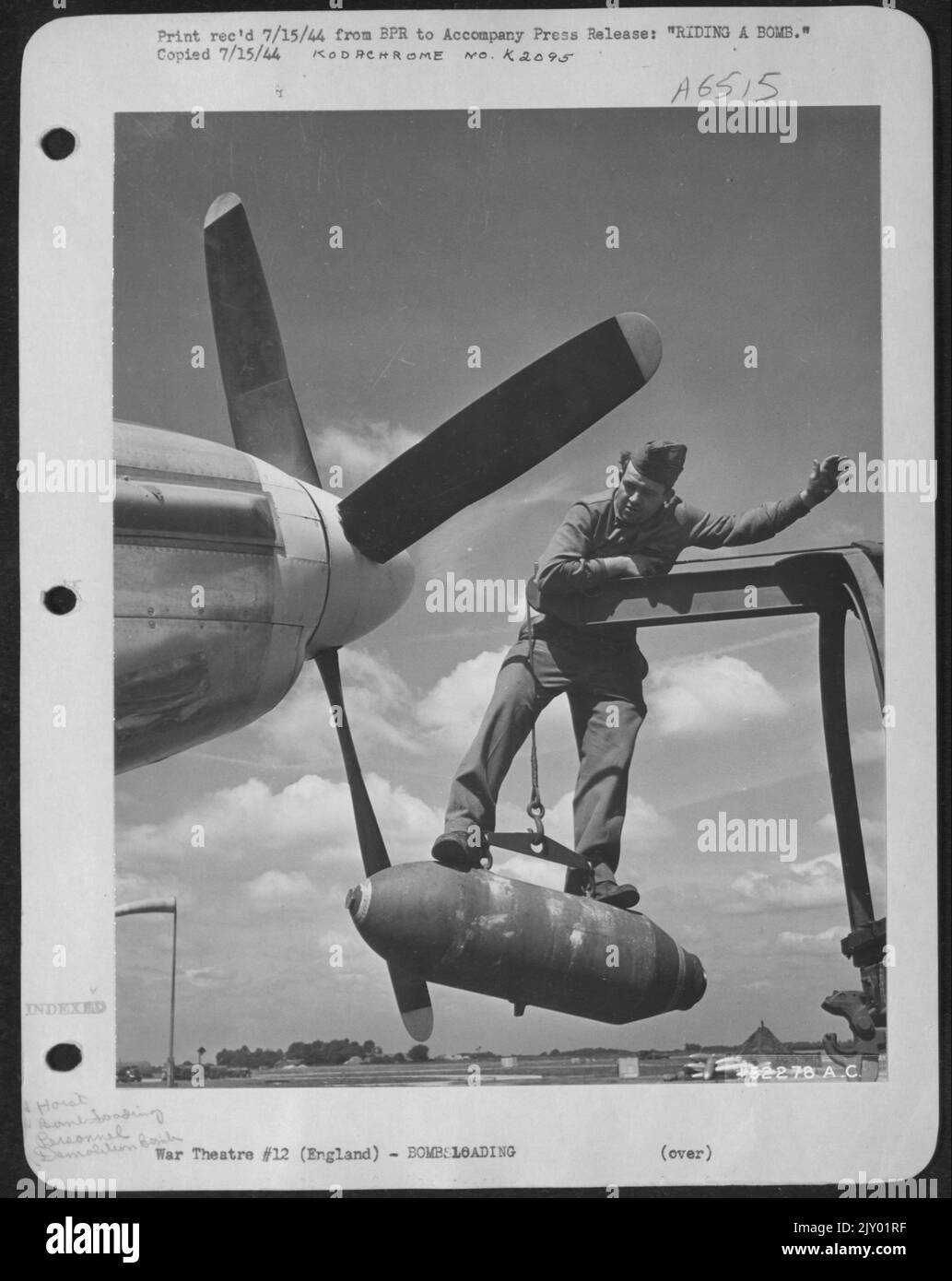 Riding a 500-pound demolition bomb to keep it steady on the end of a ...
