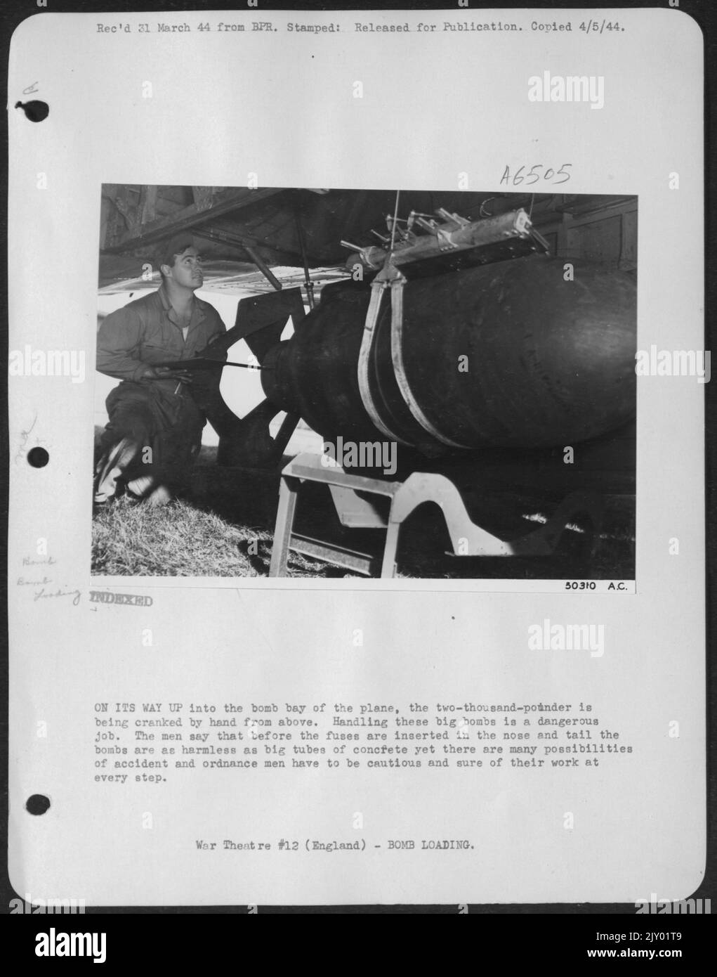 ON ITS WAY UP into the bomb bay of the plane, the two-thousand-pounder ...