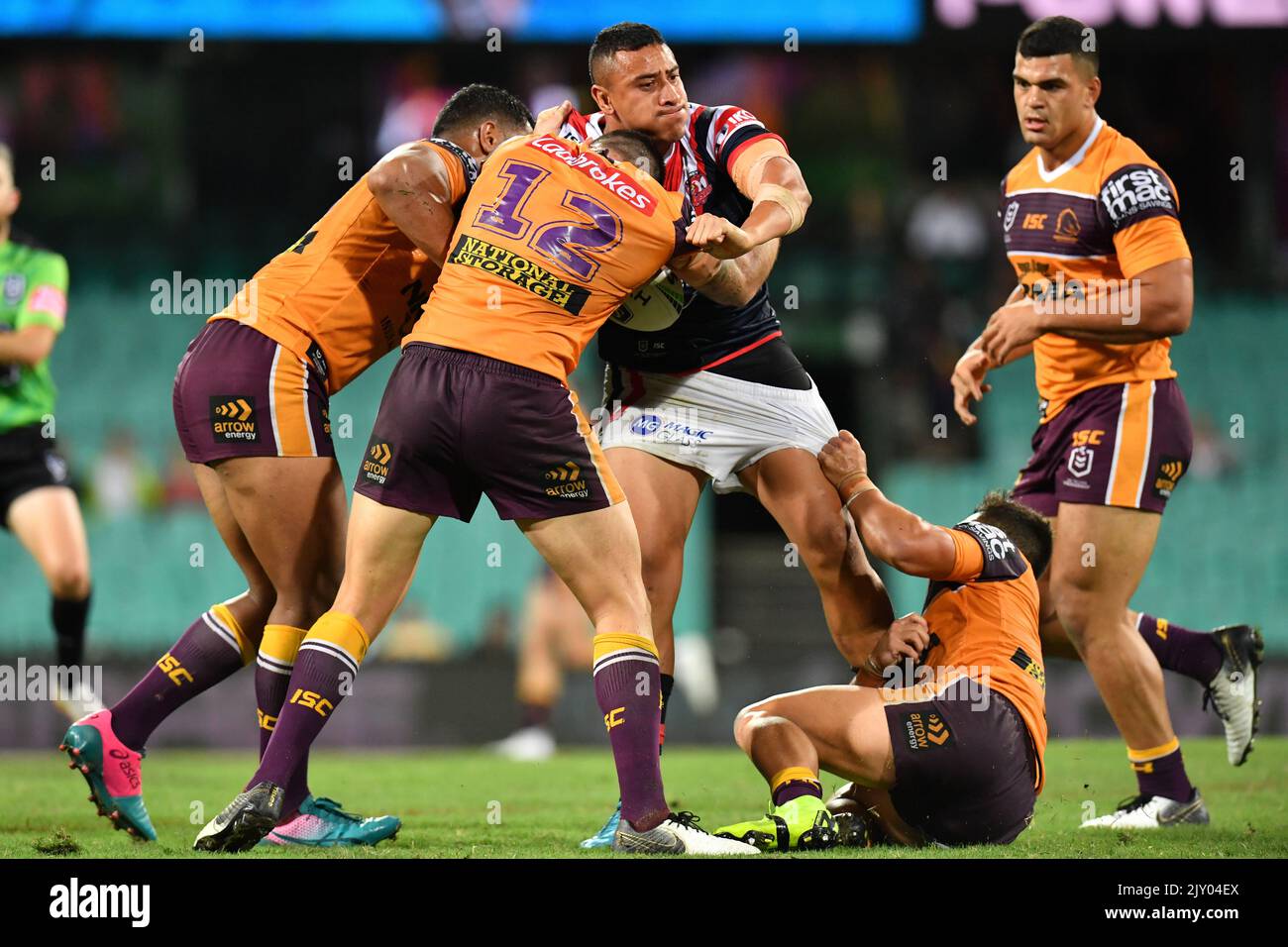 Sio Siua Taukeiaho of the Roosters is held by the Broncos defence ...
