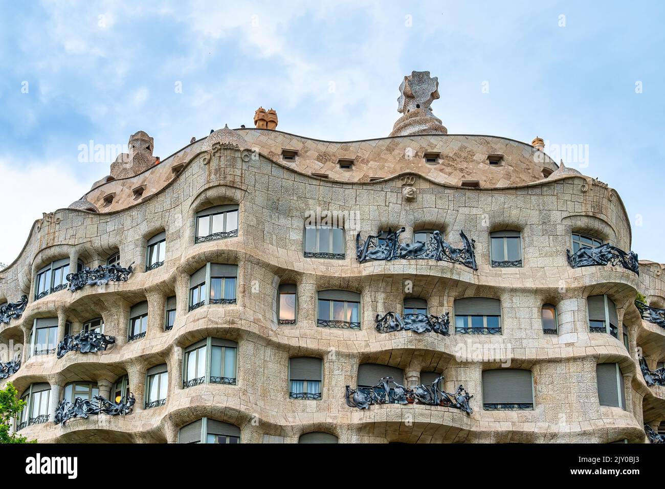The facade of Casa Mila or La Pedrera is a modernist-style building ...