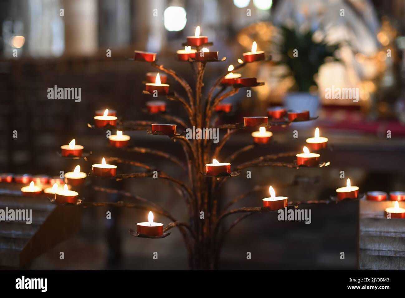 Many candles in the dark Catholic church Stock Photo - Alamy