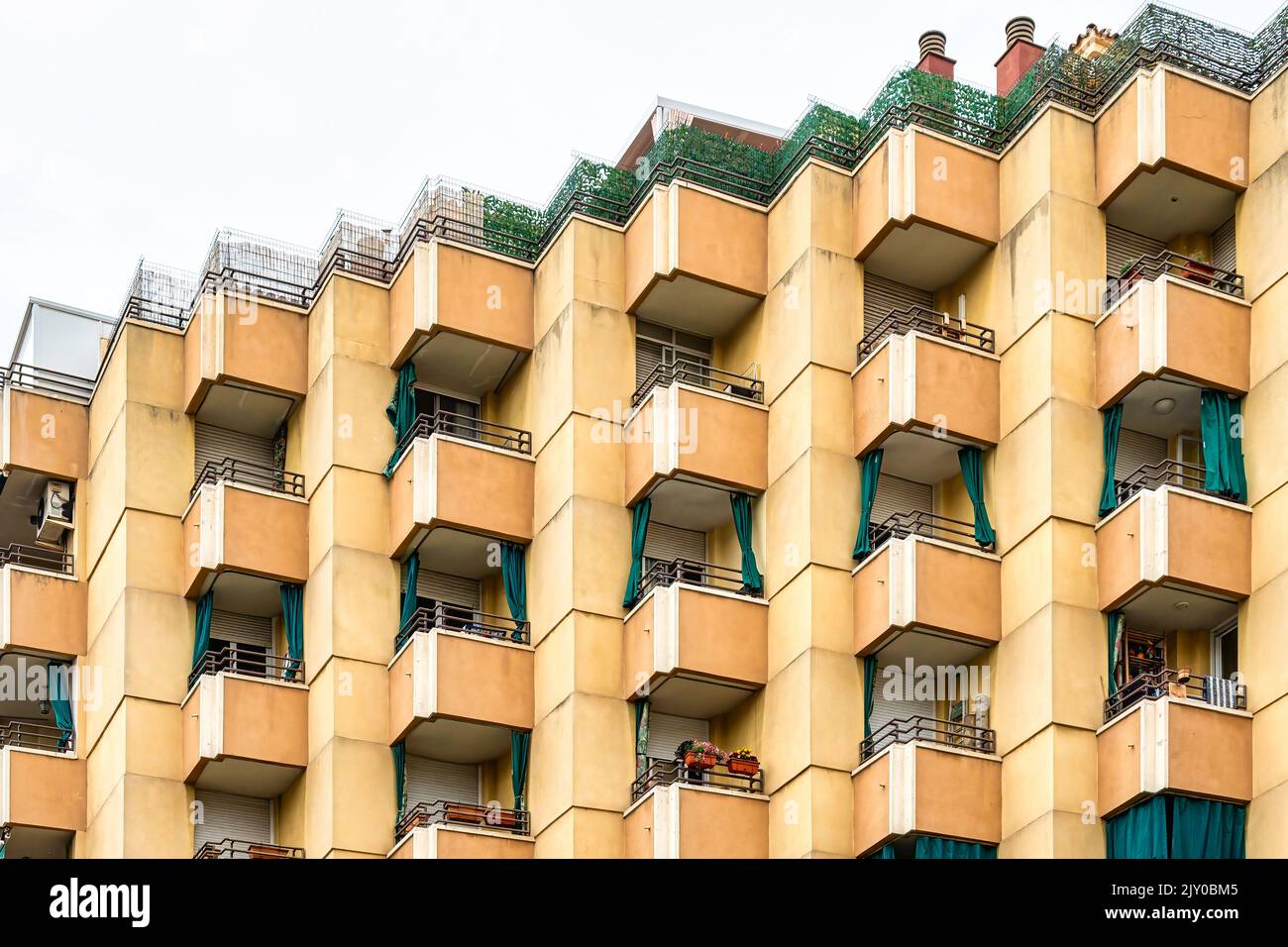 Pattern of balconies in an apartment building facade. The predominant ...