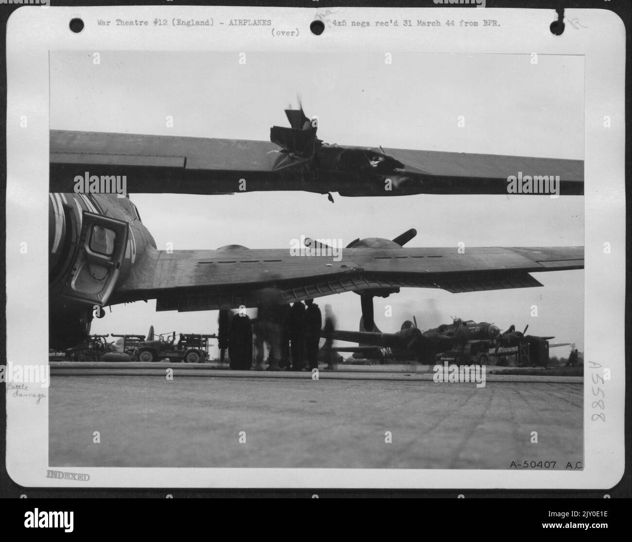 Grinnell shows other ground crew members hole in right stabilizer ...