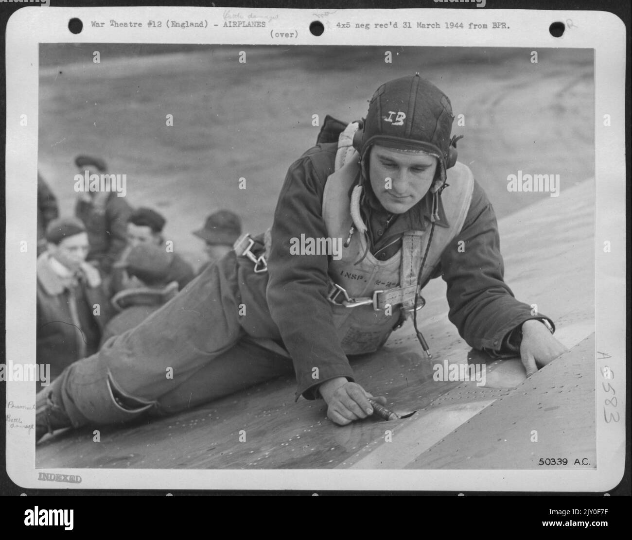 1st Lt. Earl E. Woodward, navigator of new silver Flying ofrtress, is ...