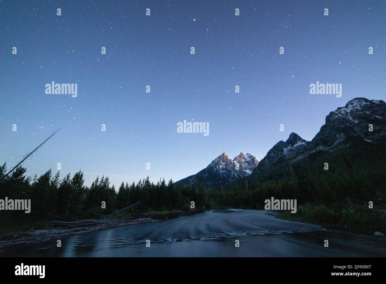 The stars coming out during twilight above the Teton Mountains and ...