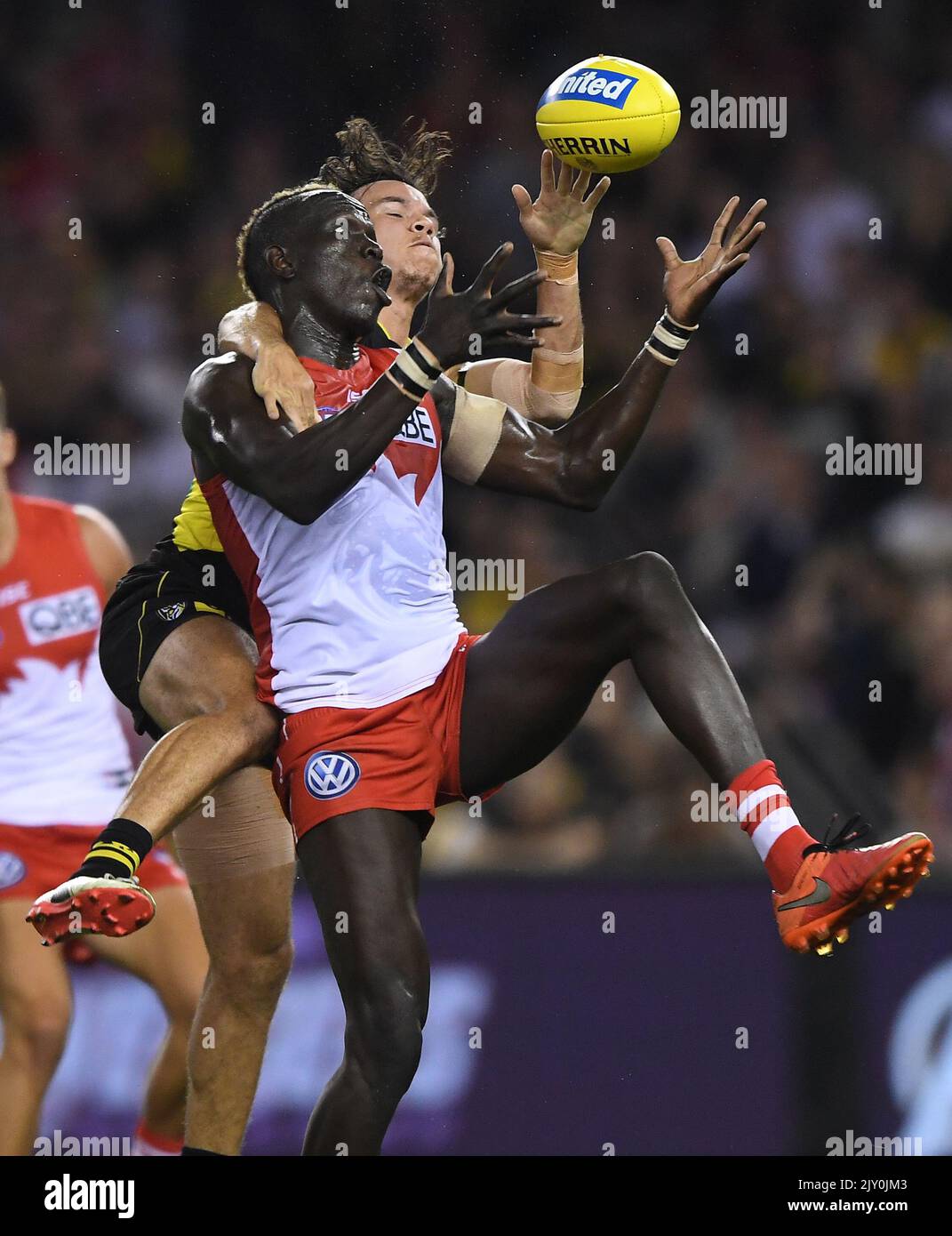 Aliir Aliir of the Swans (right) and Daniel Rioli of the Tigers contest ...