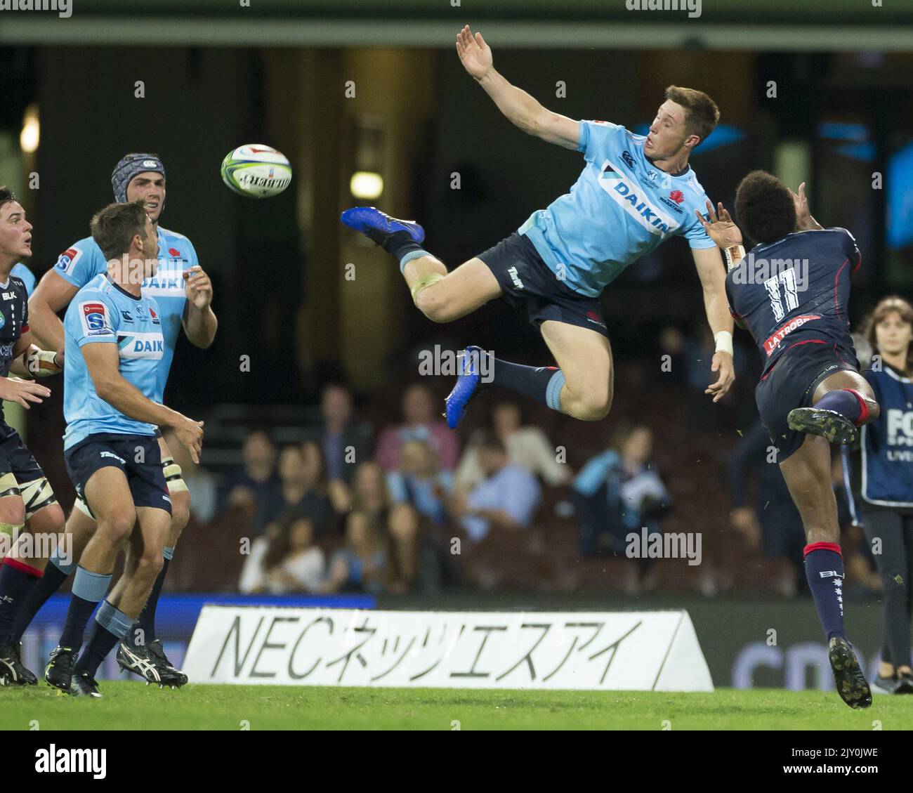Alex Newsome of the Waratahs and Marika Koroibete of the Rebels compete ...