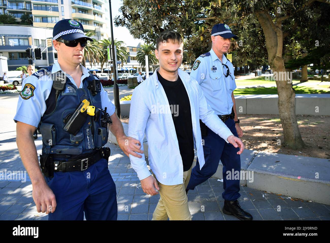 NSW Police detain a man after a confrontation with a photographer ...