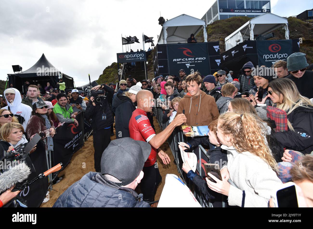 Surfer Kelly Slater signs autographs during the Rip Curl Pro at Bells ...