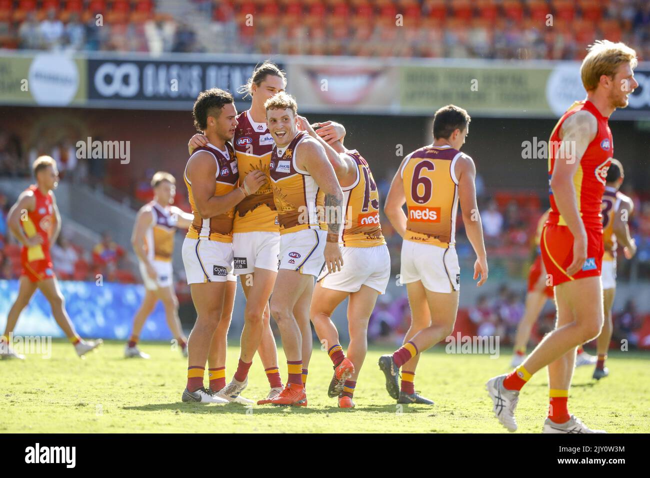 Mitch Robinson of the Lions celebrates with teammates after scoring a ...
