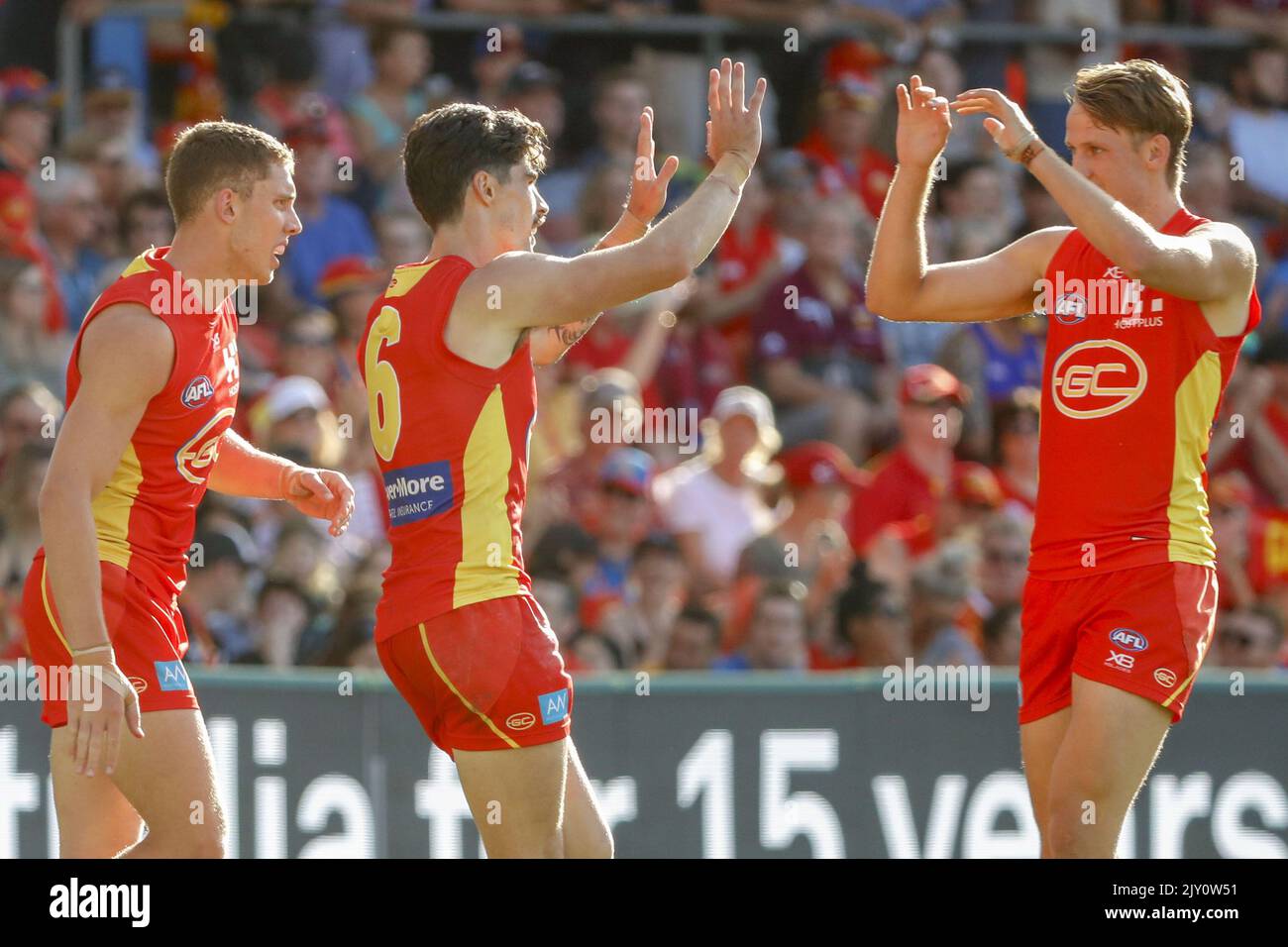 Alex Sexton (second from left) of the Suns celebrates scoring a goal ...