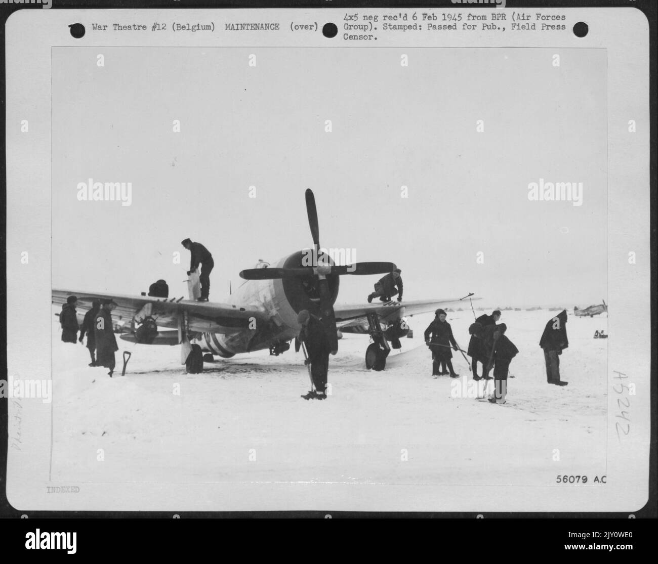Belgium civilians at a 9th AF fighter base are cleaning the snow from ...