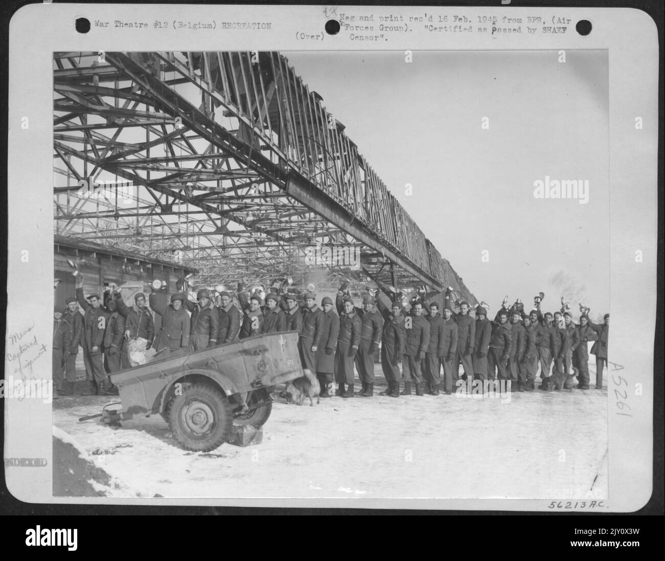 Enlisted men of the 365th Fighter-bomber group ofrm a mess line under ...
