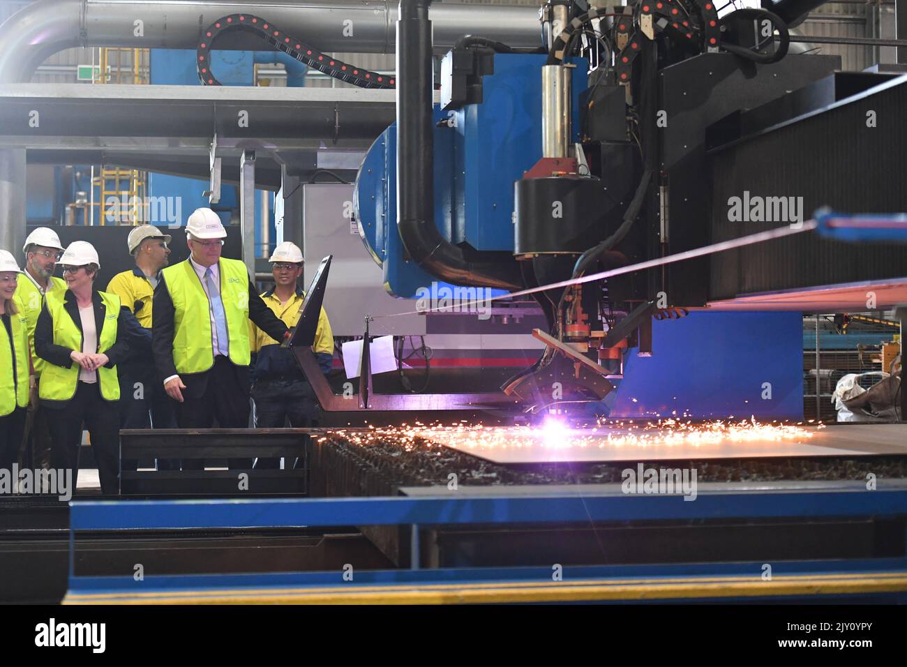 Prime Minister Scott Morrison starts a laser cutter while visiting ...