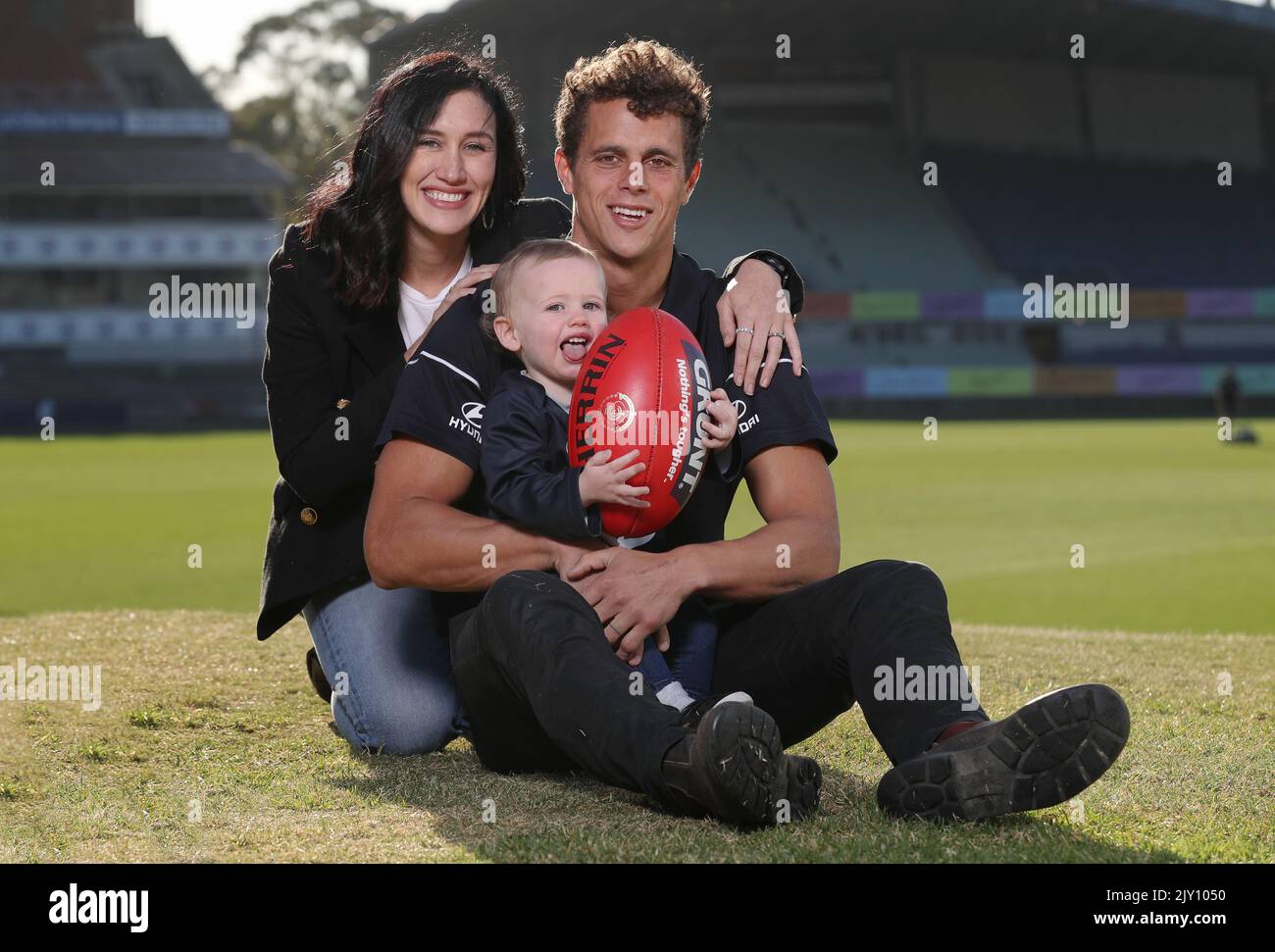 Carlton player Ed Curnow poses for a photograph with wife Emily and son ...