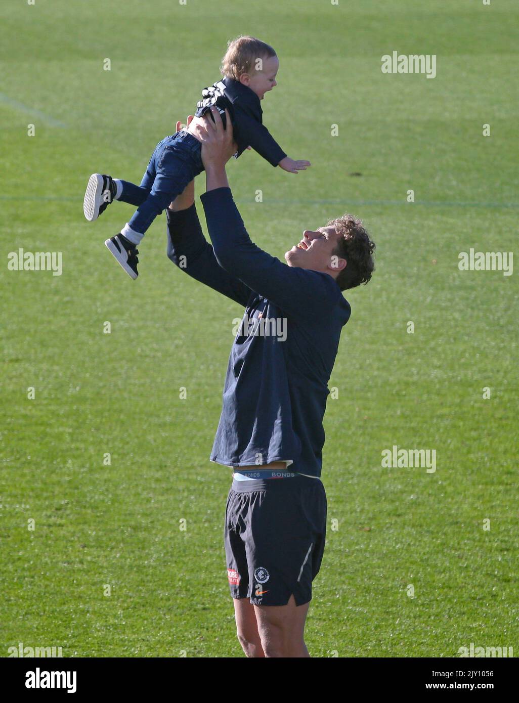 Carlton player Ed Curnow is seen with his son Will at the Carlton ...
