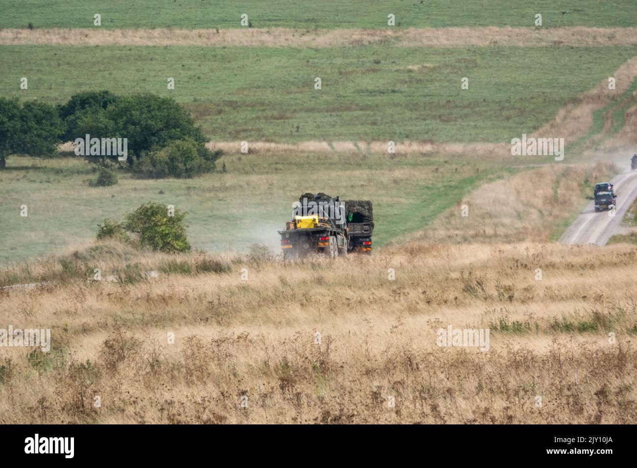British army MAN HX58 Heavy Utility Trucks driving along a stone dirt ...