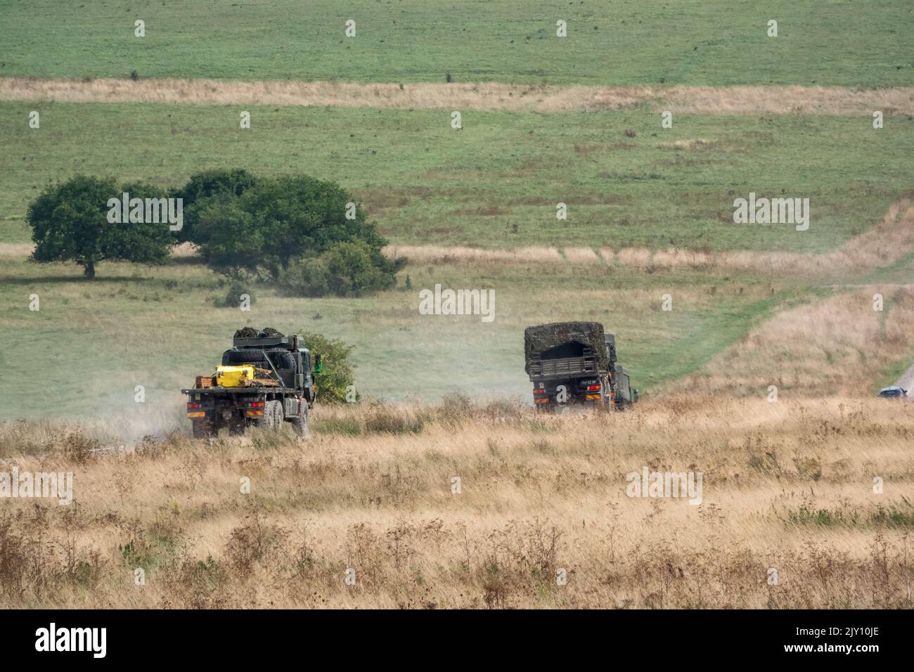 British army MAN HX58 Heavy Utility Trucks driving along a stone dirt ...