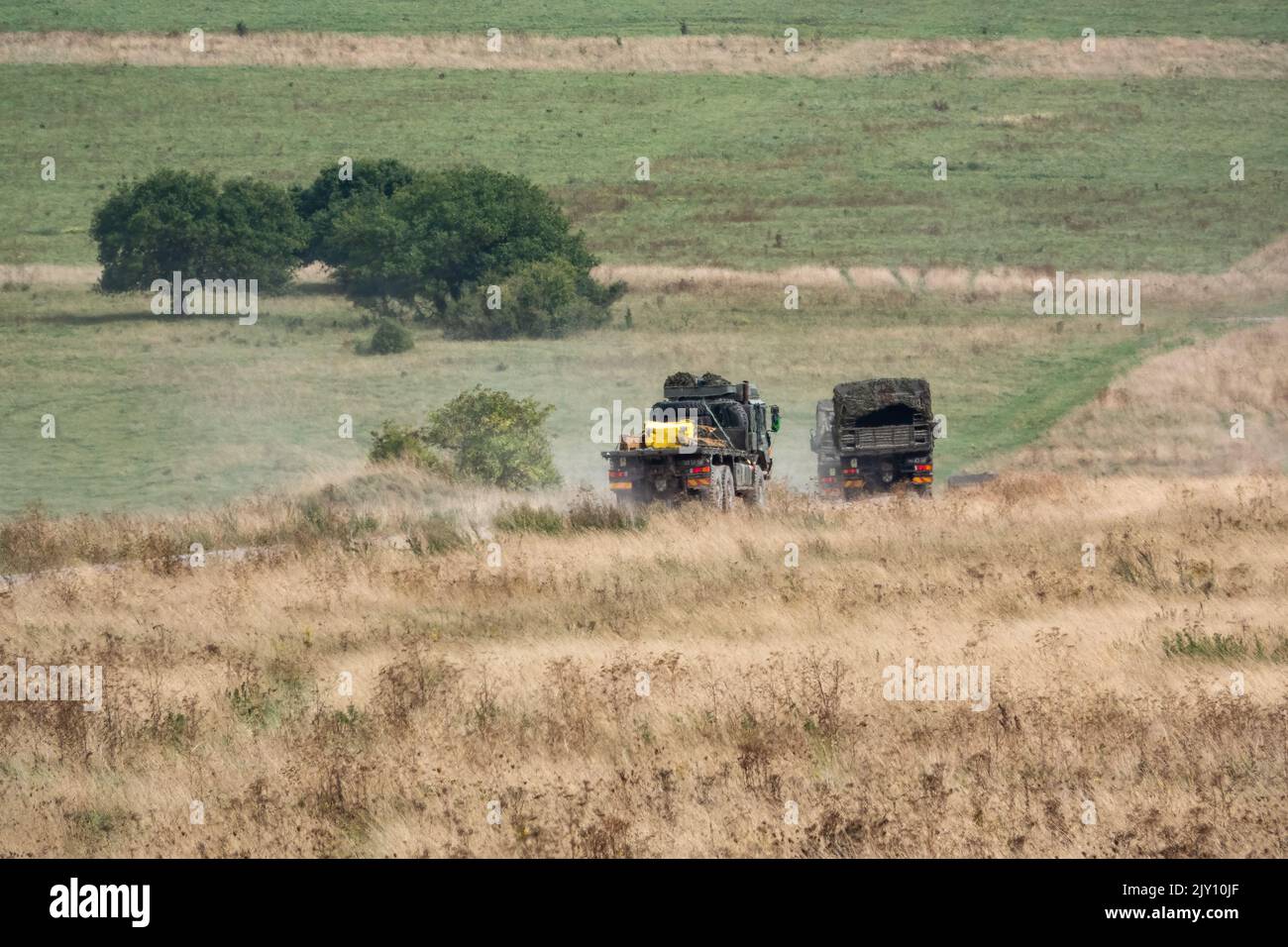 British army MAN HX58 Heavy Utility Trucks driving along a stone dirt ...