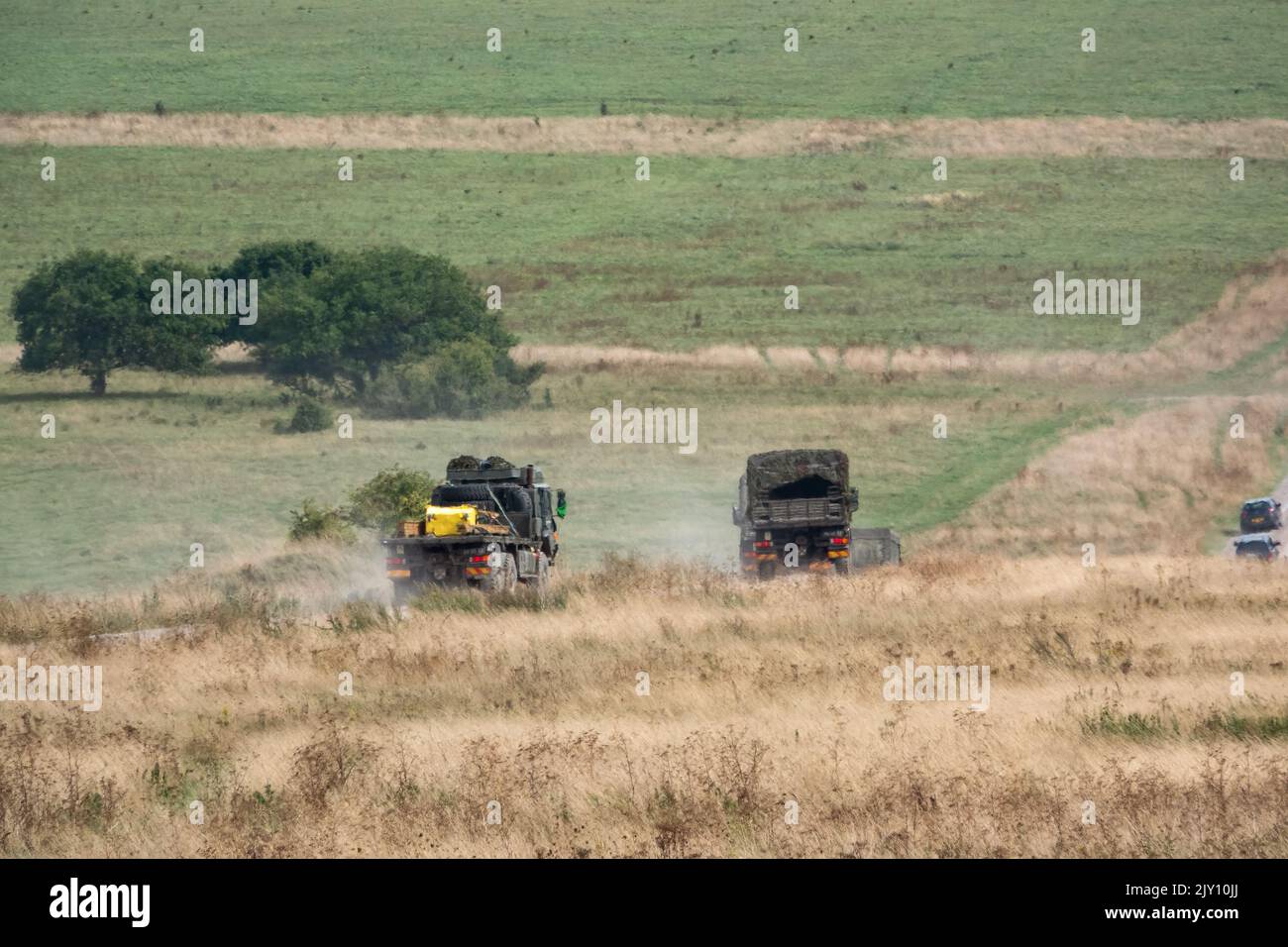 British army MAN HX58 Heavy Utility Trucks driving along a stone dirt ...