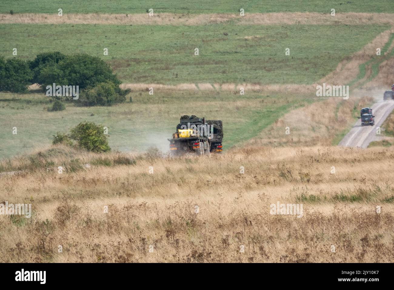 British army MAN HX58 Heavy Utility Trucks driving along a stone dirt ...