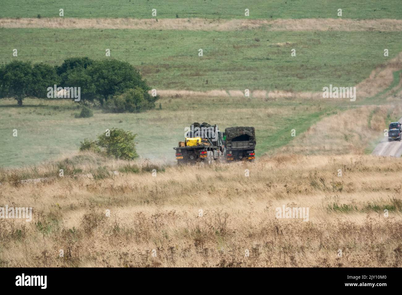 British army MAN HX58 Heavy Utility Trucks driving along a stone dirt ...